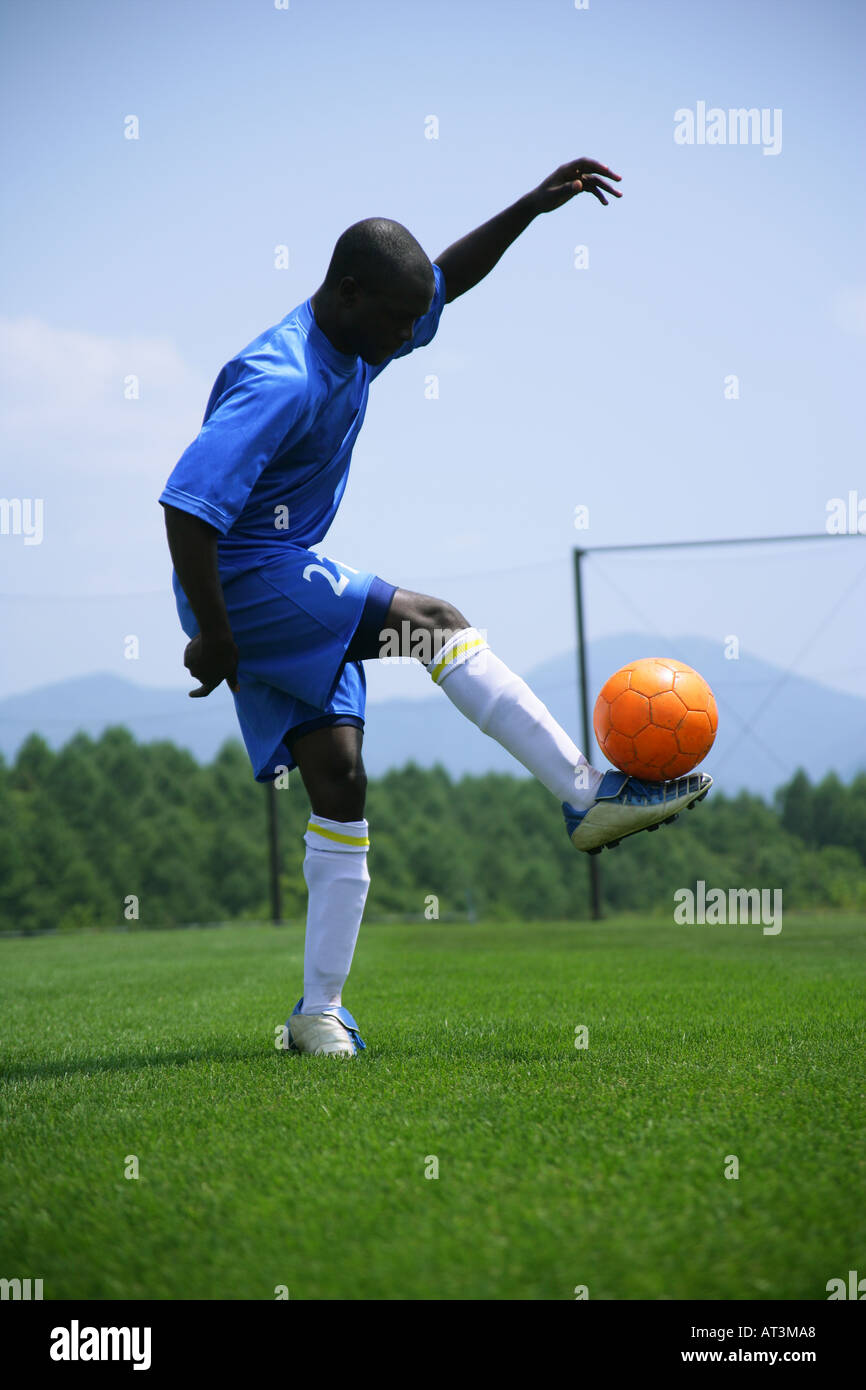 Soccer player juggling ball Stock Photo - Alamy