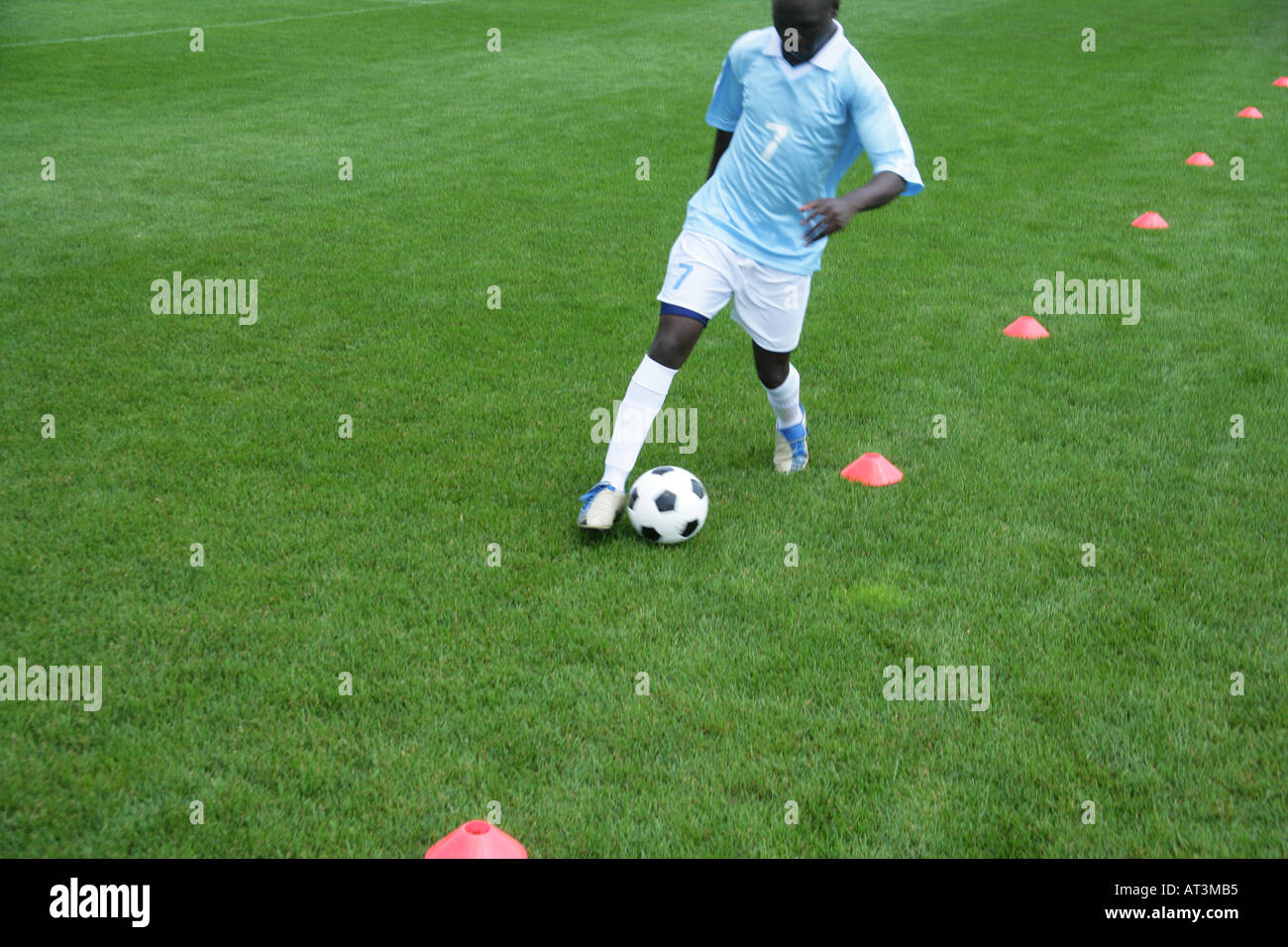 Soccer player dribbling through cones hi-res stock photography and ...