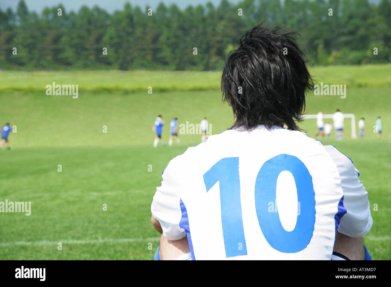 Back of soccer player watching game from side Stock Photo - Alamy