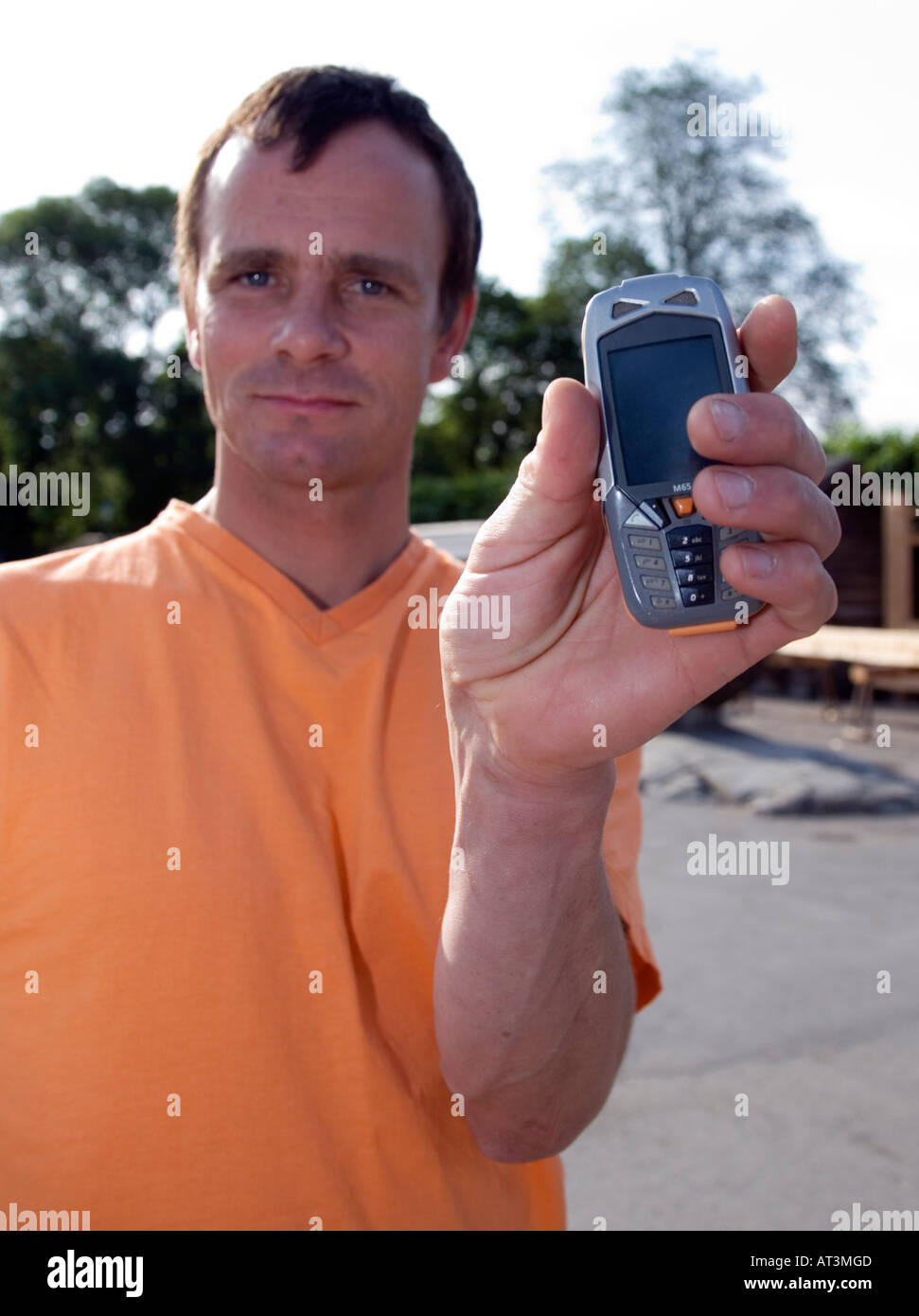 Model released portrait of a man holding a cellphone Stock Photo - Alamy