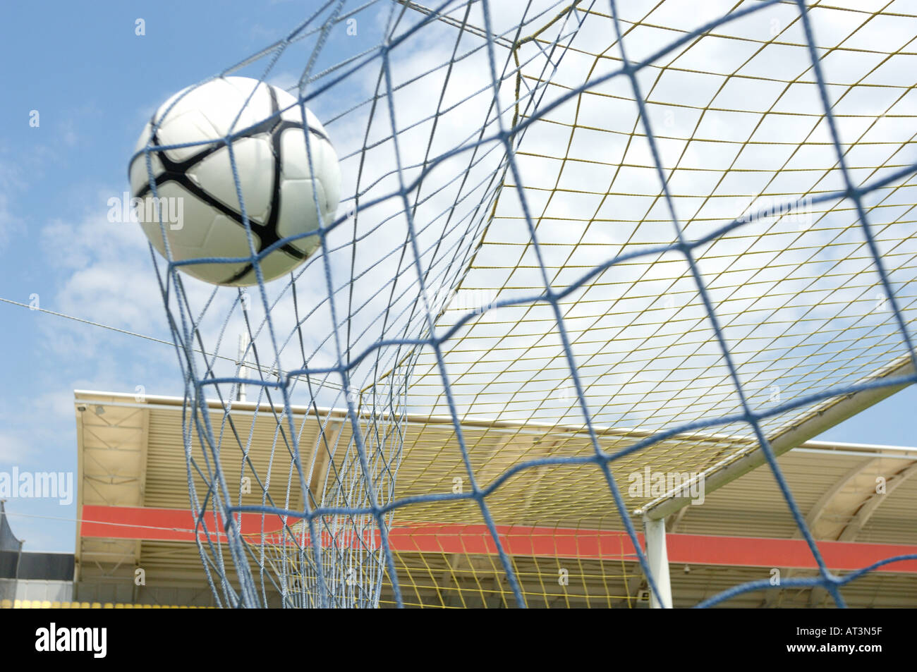 Soccer ball hitting back of net Stock Photo - Alamy