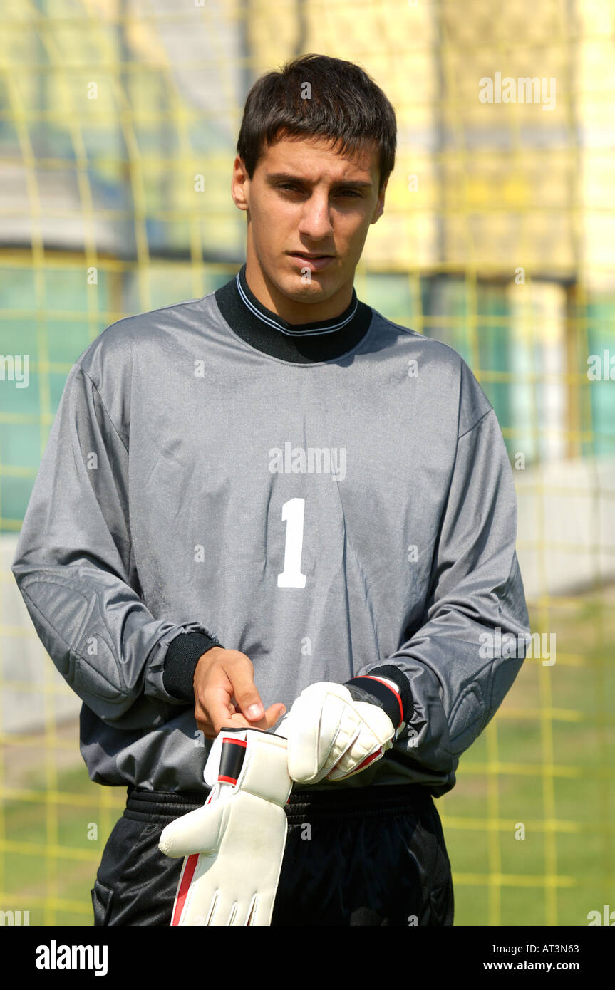 Goalkeeper putting on gloves Stock Photo - Alamy