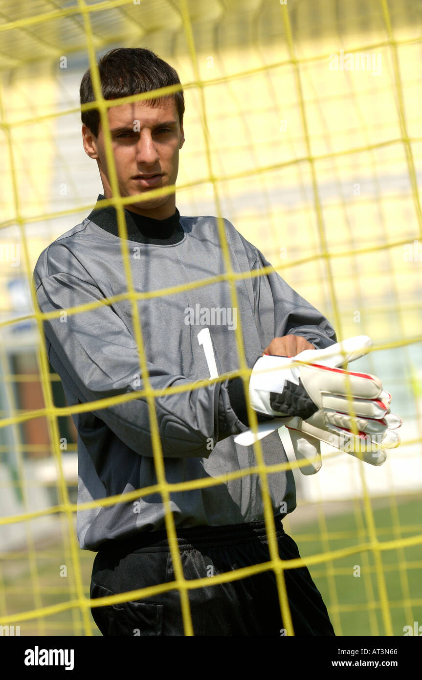 Goalkeeper putting on gloves Stock Photo - Alamy