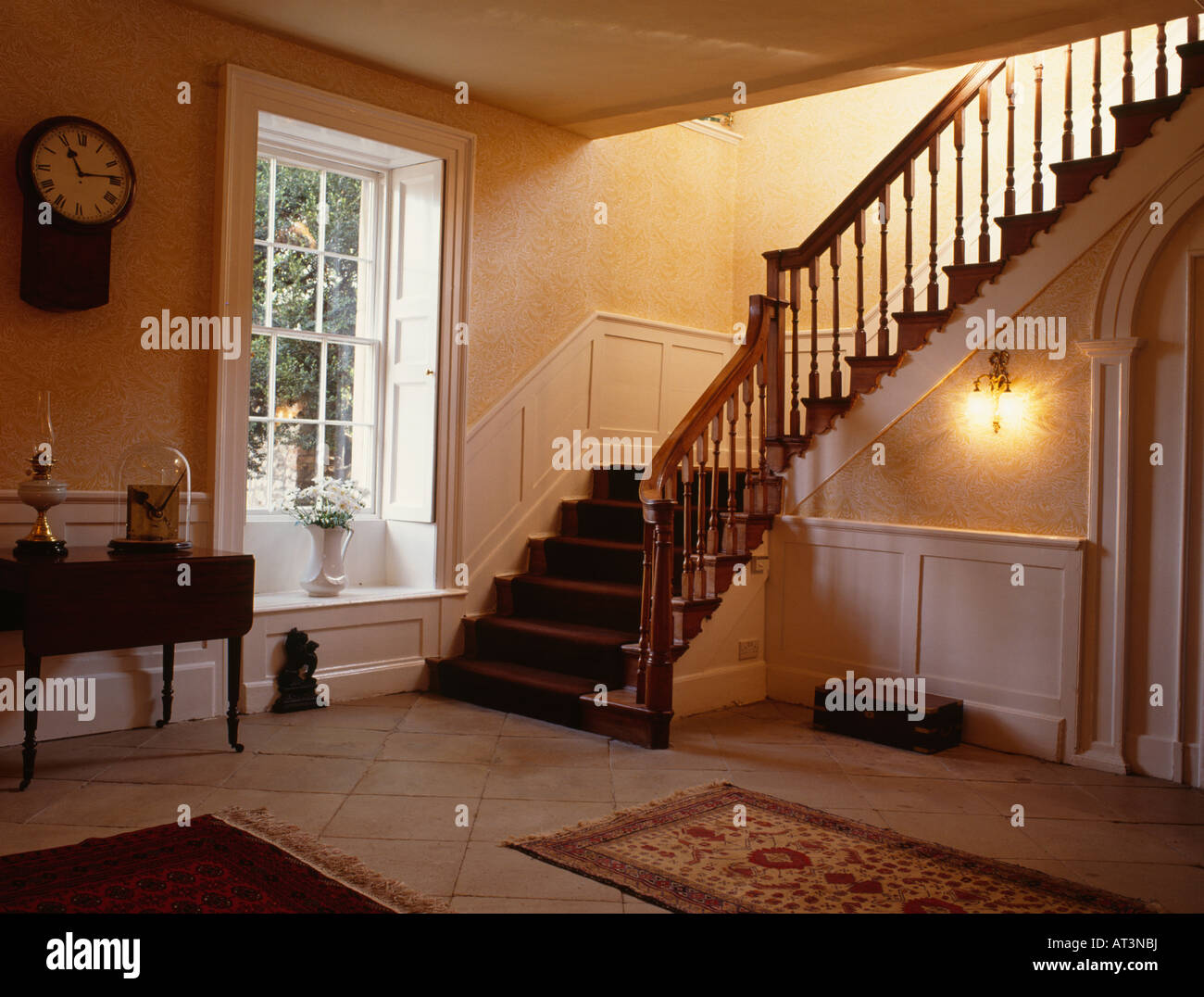 Staircase and large traditional hall with sash window Stock Photo - Alamy