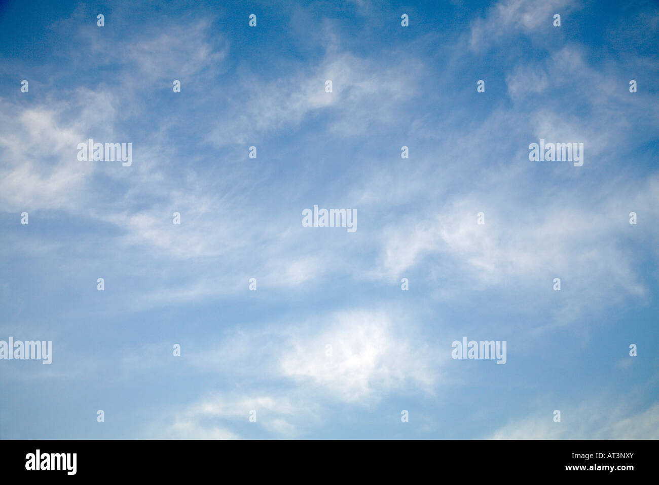Bright blue sky with white tenuous mass of gossamer clouds Stock Photo - Alamy