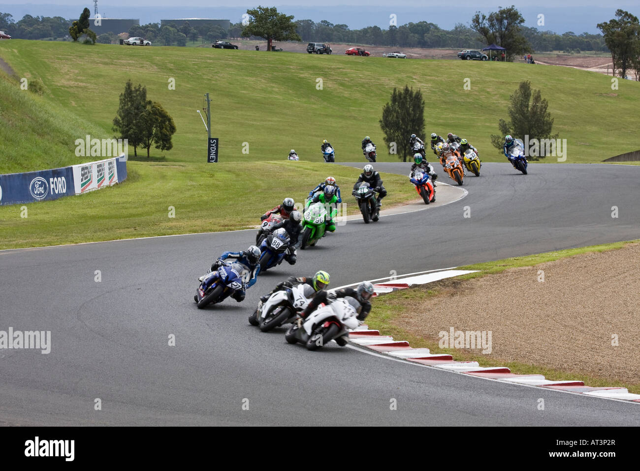A string of motorbikes wends its way between turns 6 and 7 at Eastern ...