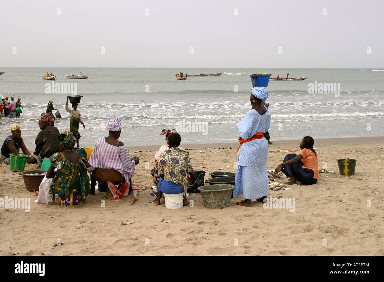 The Gambia Gunjur villagers awaiting return of fishing boats to unload ...