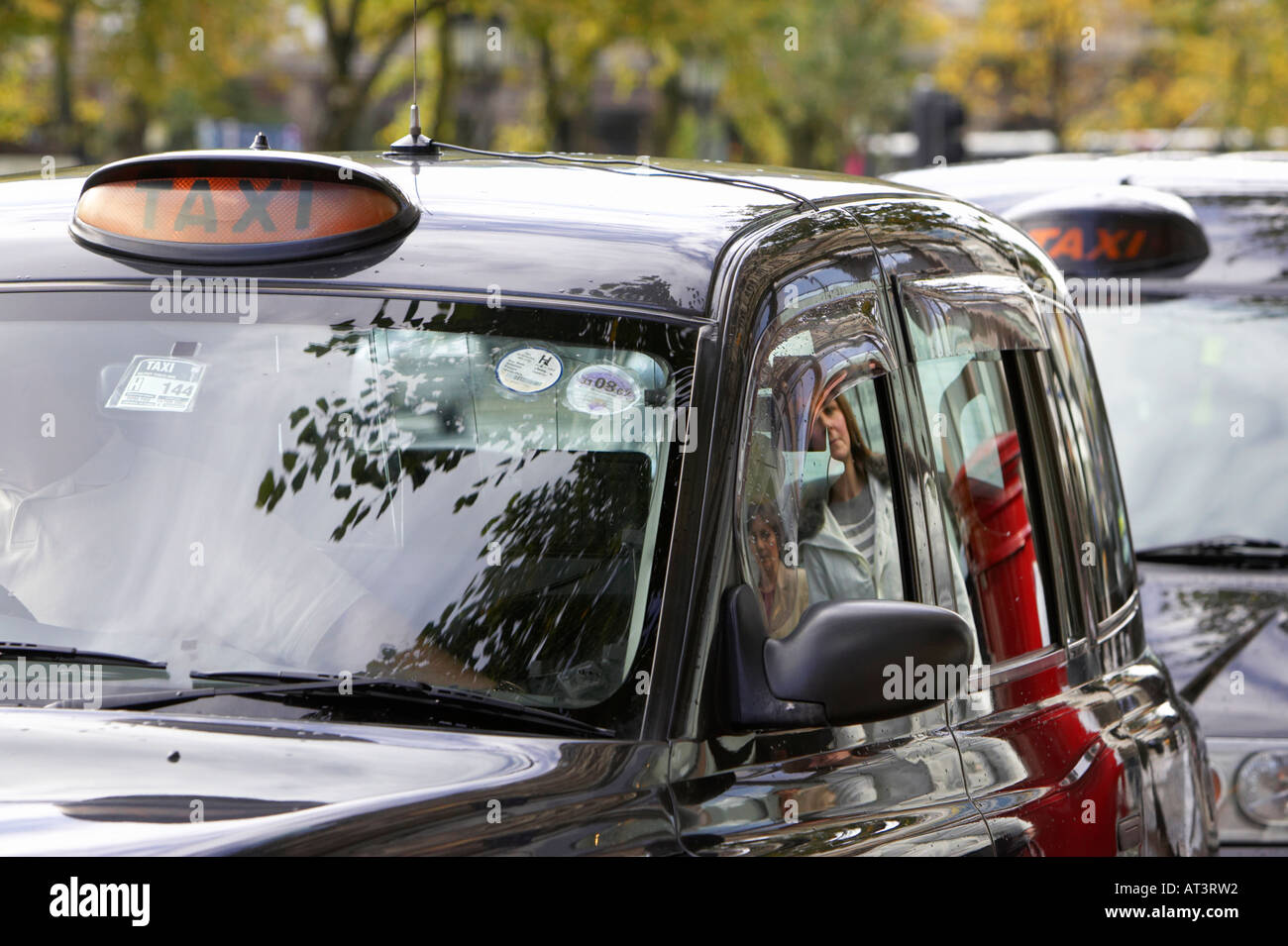 two black london hackey carriage taxis on a rank in Belfast City Centre ...