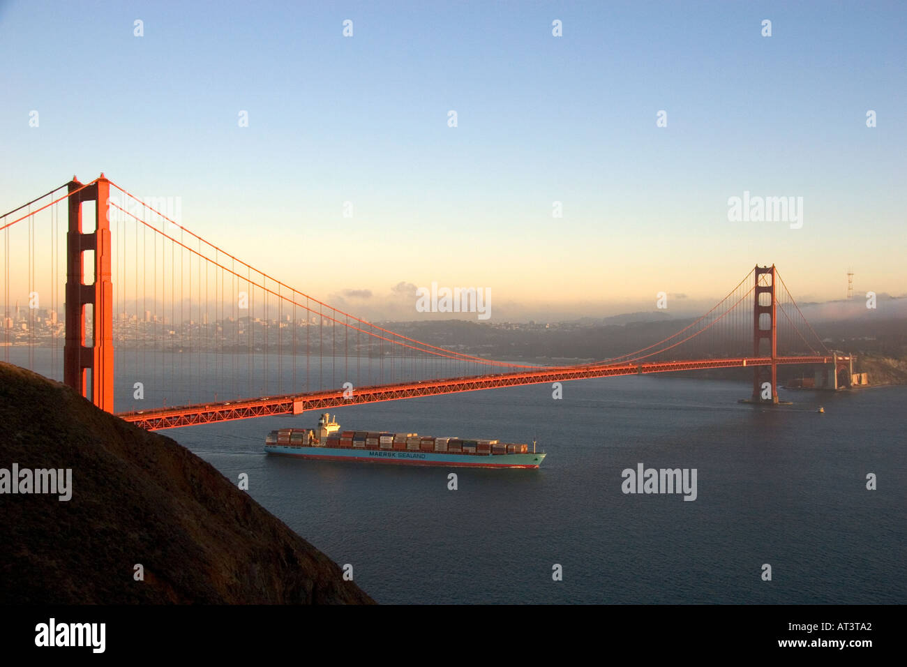 A container ship passes under the Golden Gate Bridge in the San ...