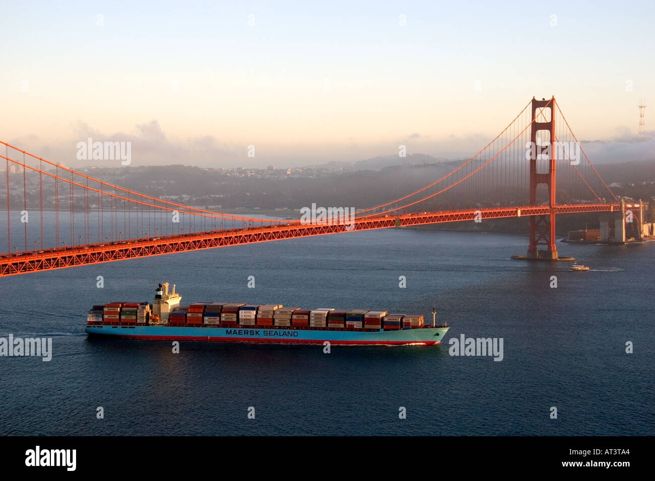 A container ship passes under the Golden Gate Bridge in the San ...
