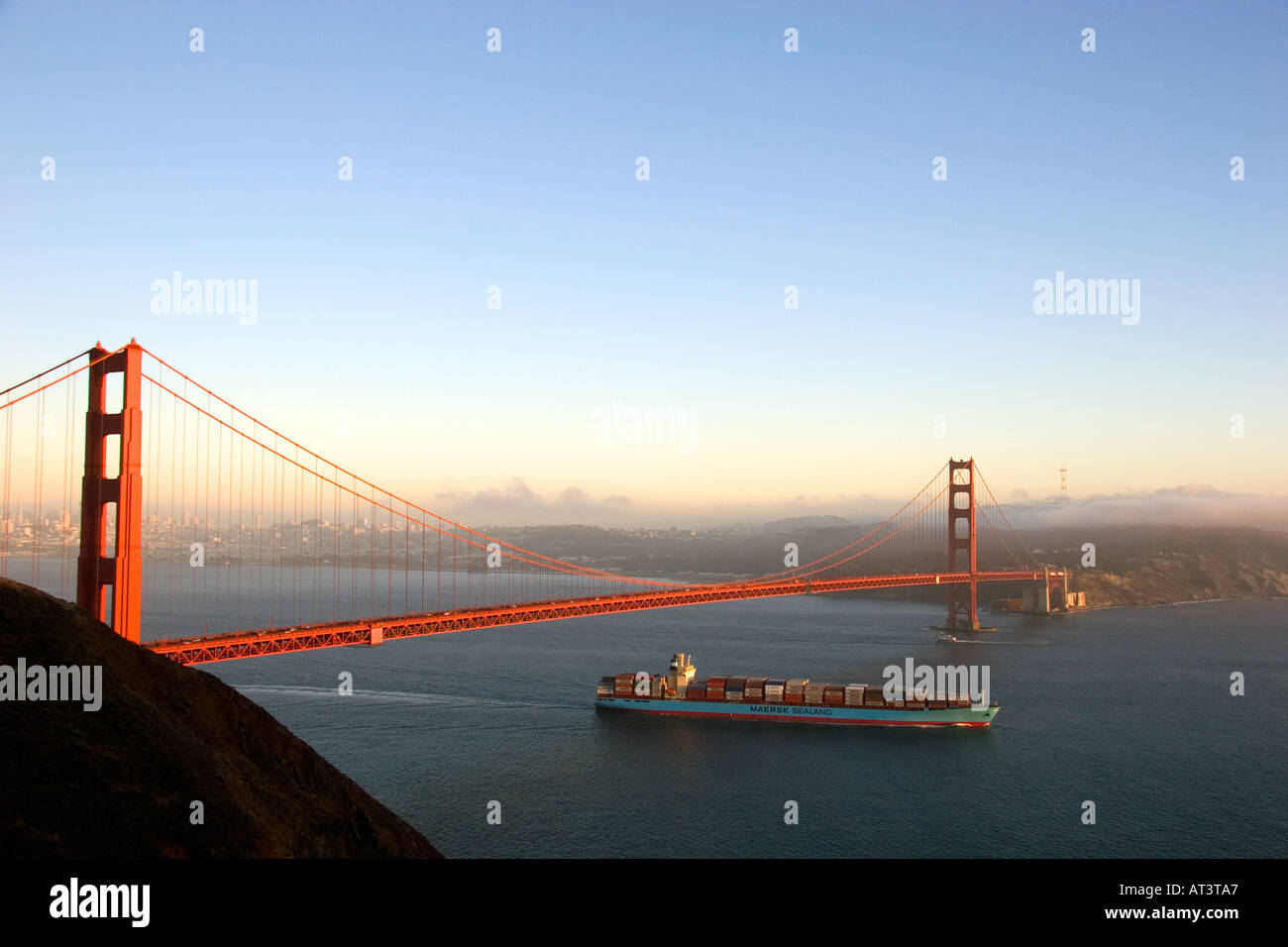 A container ship passes under the Golden Gate Bridge in the San ...