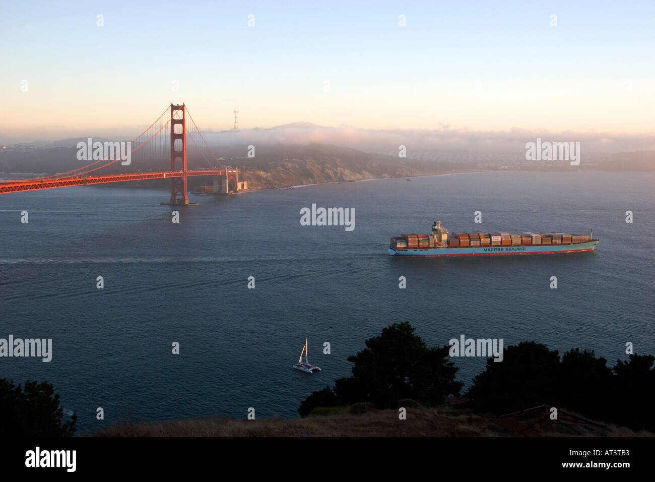A container ship passes under the Golden Gate Bridge in the San ...