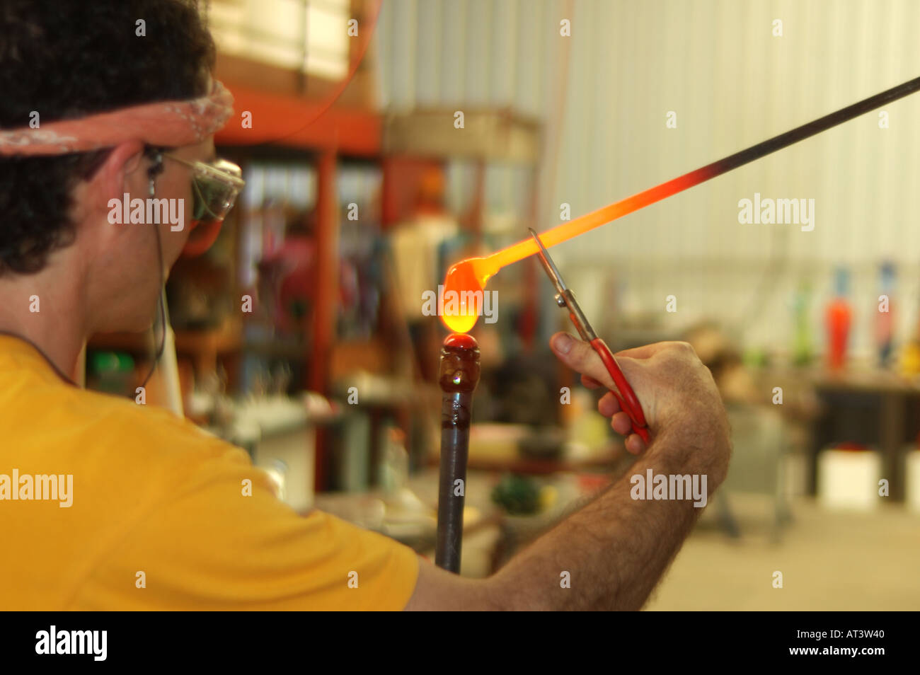 Glass artist cutting glass with snips ready for blowing Sunshine coast ...