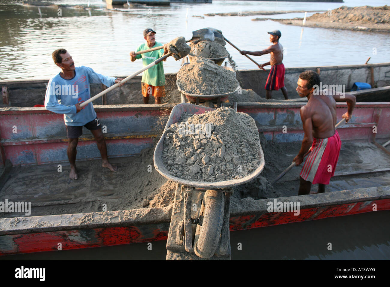Poor people dig sand from the bottom of the river and transport it with ...