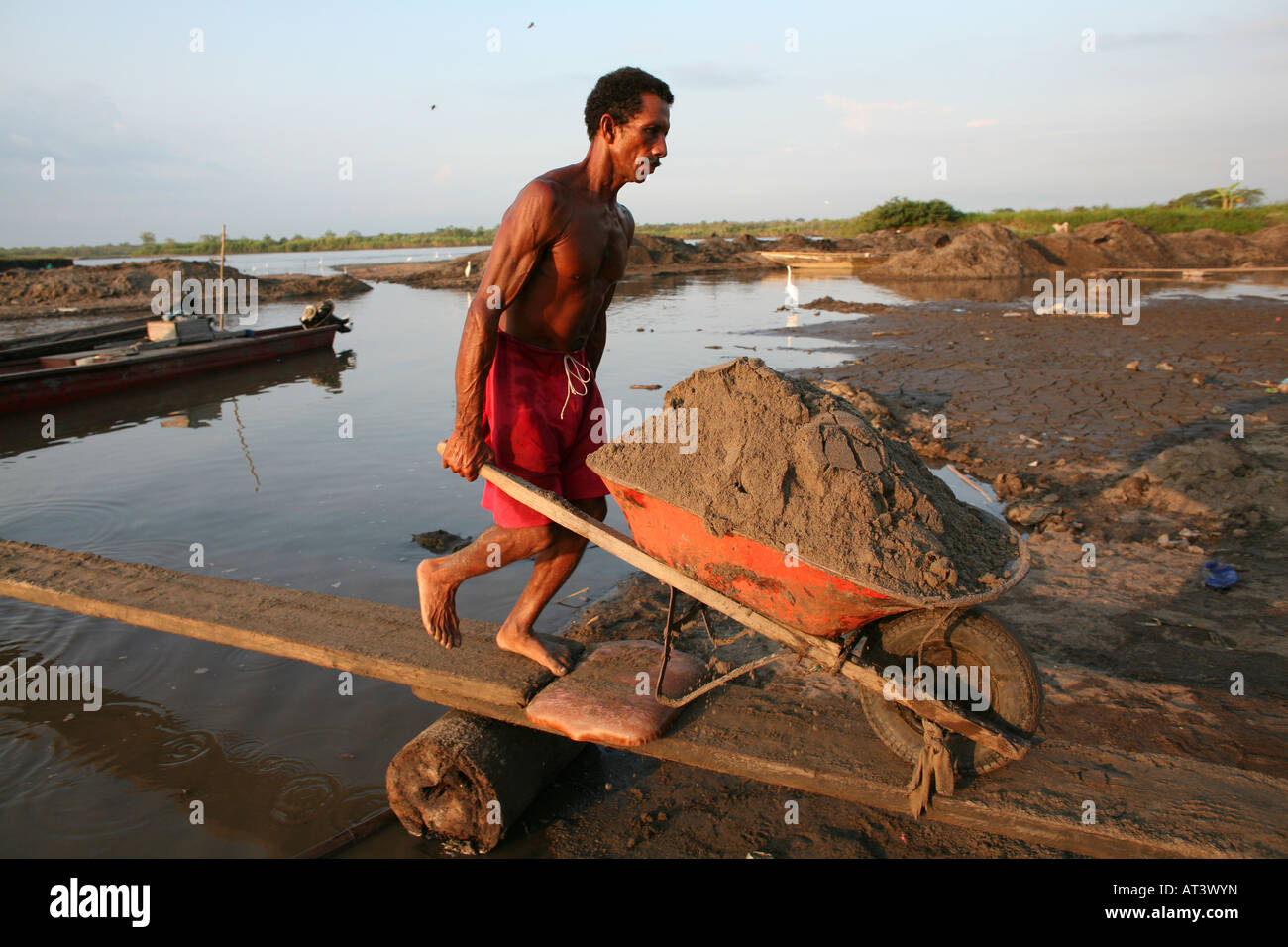 Poor people dig sand from the bottom of the river and transport it with ...