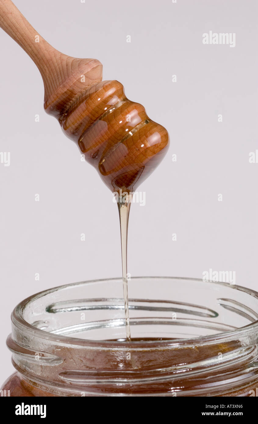 Honey Stick Pouring Honey from a Jar Stock Photo - Alamy