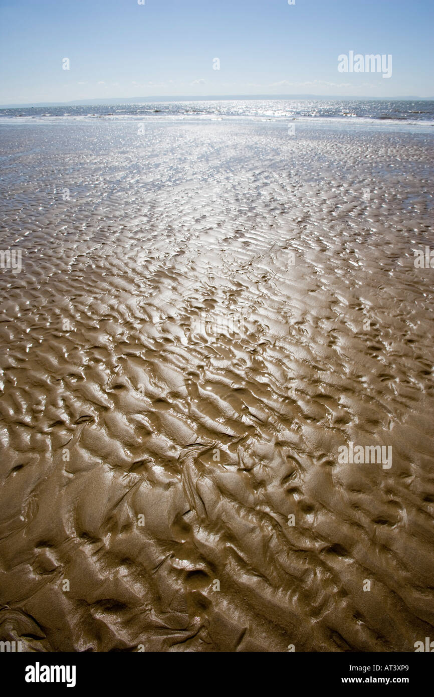 Sandy beach with wet sand and water reflections Stock Photo - Alamy