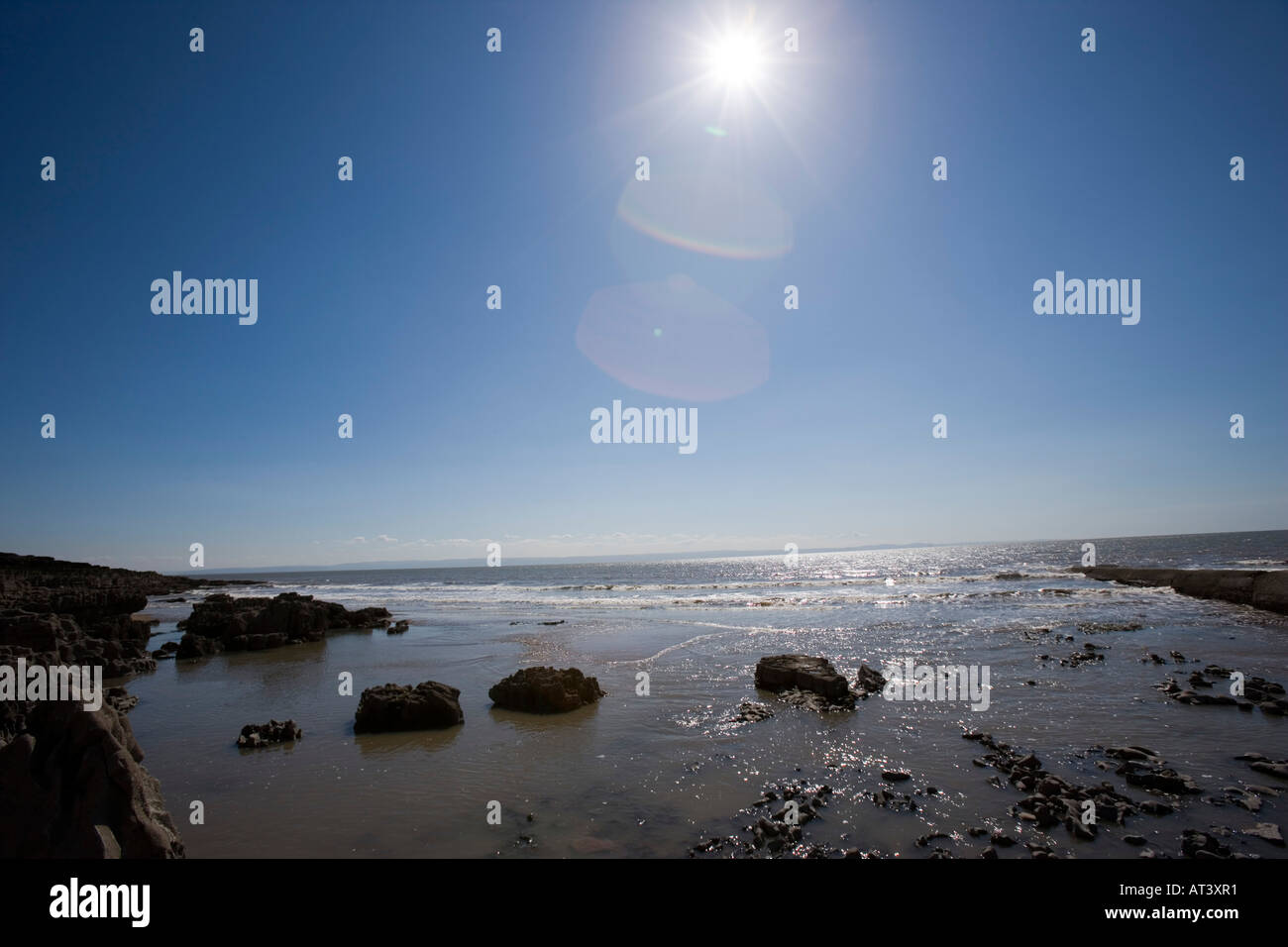 Sun s rays shining on rock pools at seaside Stock Photo - Alamy