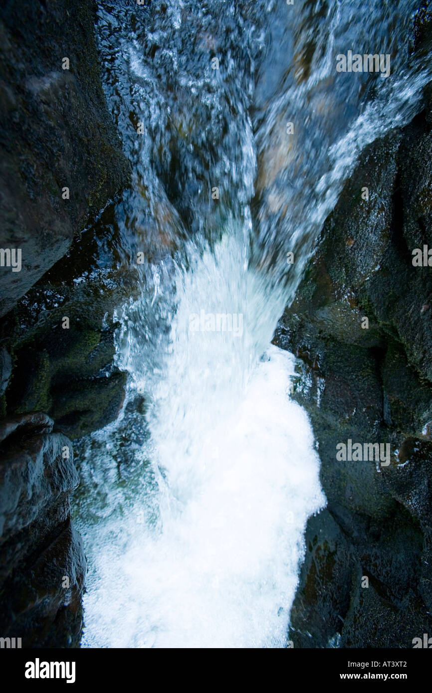Waterfall flowing through large rocks Stock Photo - Alamy