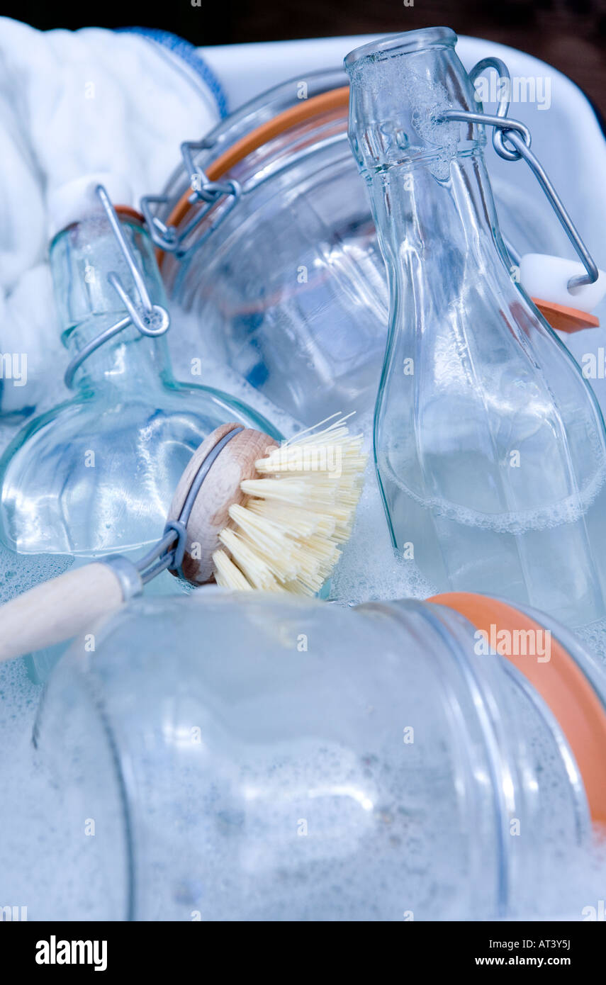 Enamel Washing up bowl and glassware Stock Photo - Alamy