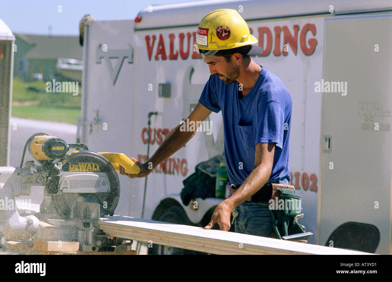 Construction worker using a compound miter saw Stock Photo - Alamy