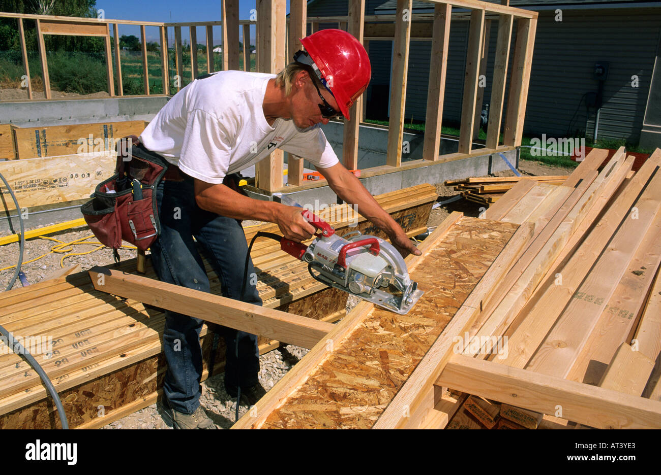 Construction worker using a power saw to cut an I-beam to size Stock ...