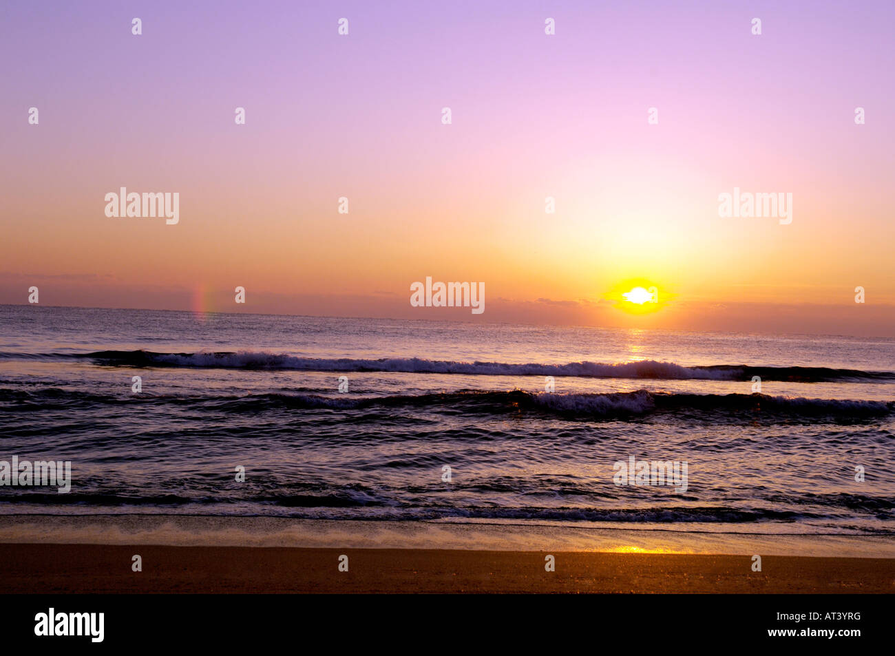 Early morning sunrise over Delray Public Beach Florida with a burst of ...