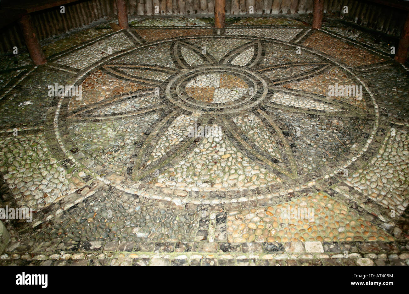Decorative stone floor made from coloured pebbles formed into a star ...