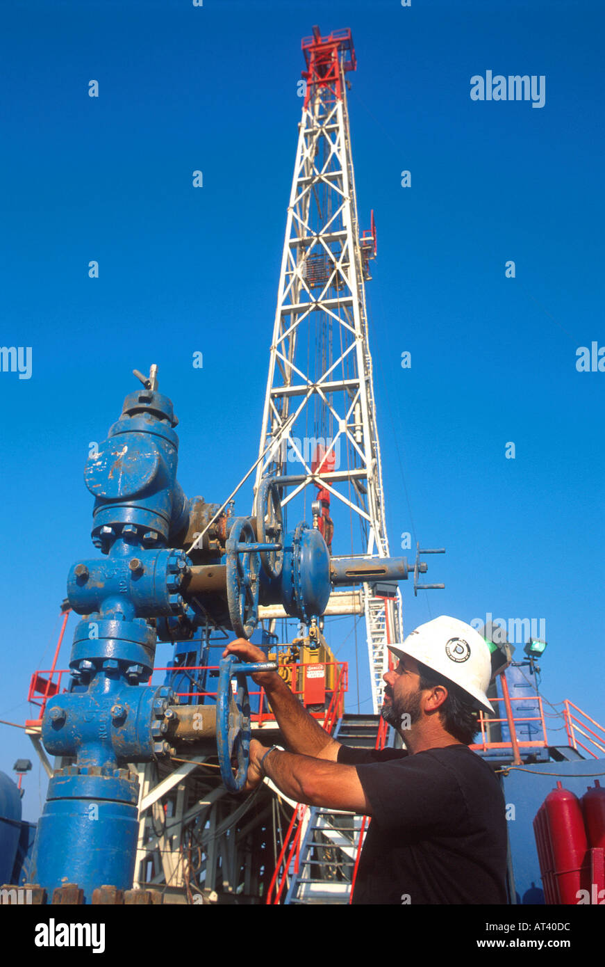 Man working on a Texas oil well Stock Photo - Alamy