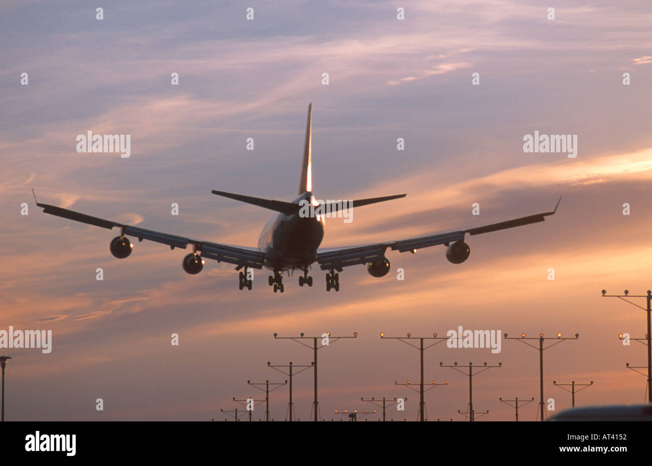 Boeing 747 landing at sunset at LAX airport in Los Angeles California ...