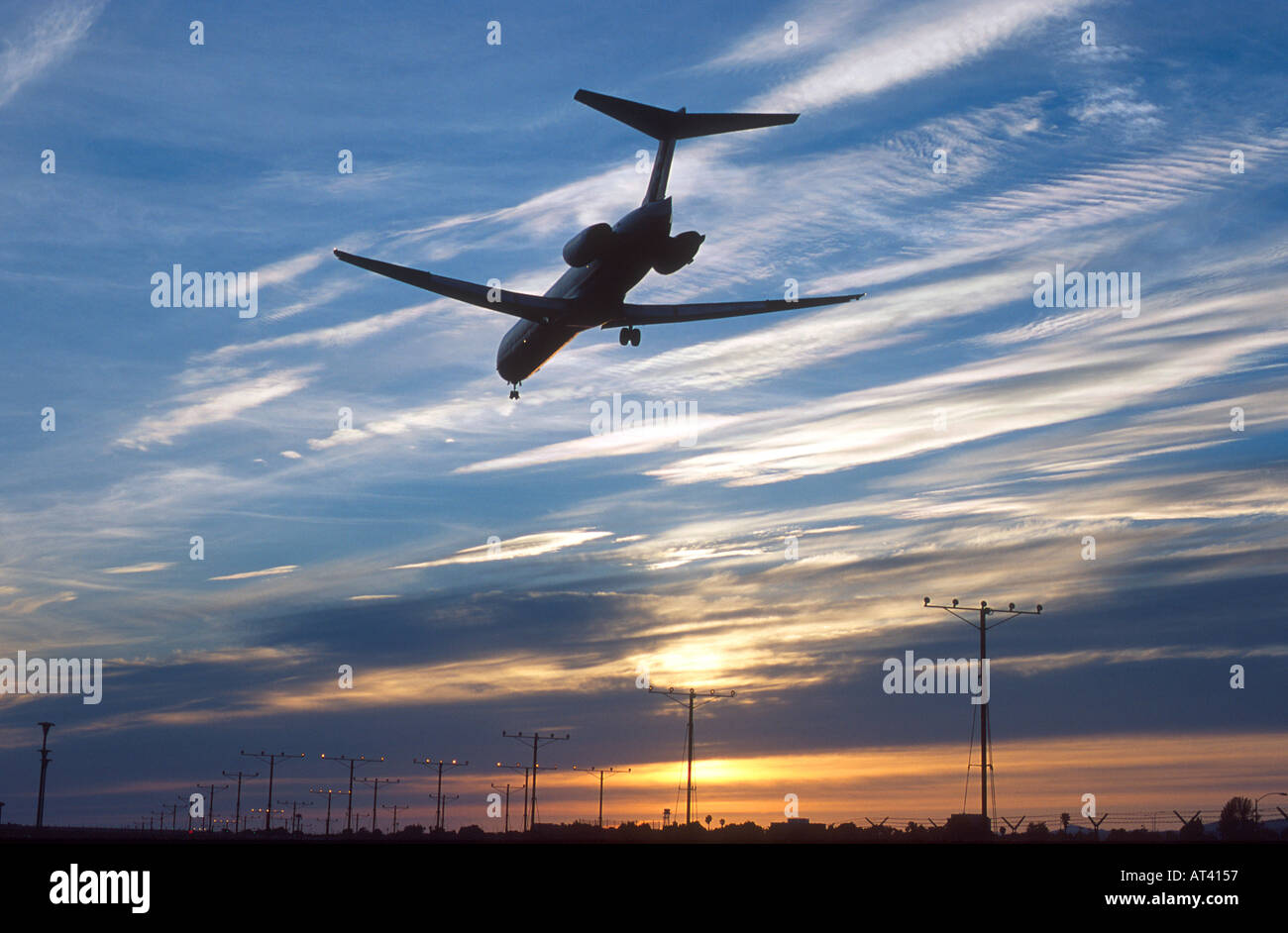 Boeing 717 MD 80 landing at sunset dusk at LAX Los Angeles ...
