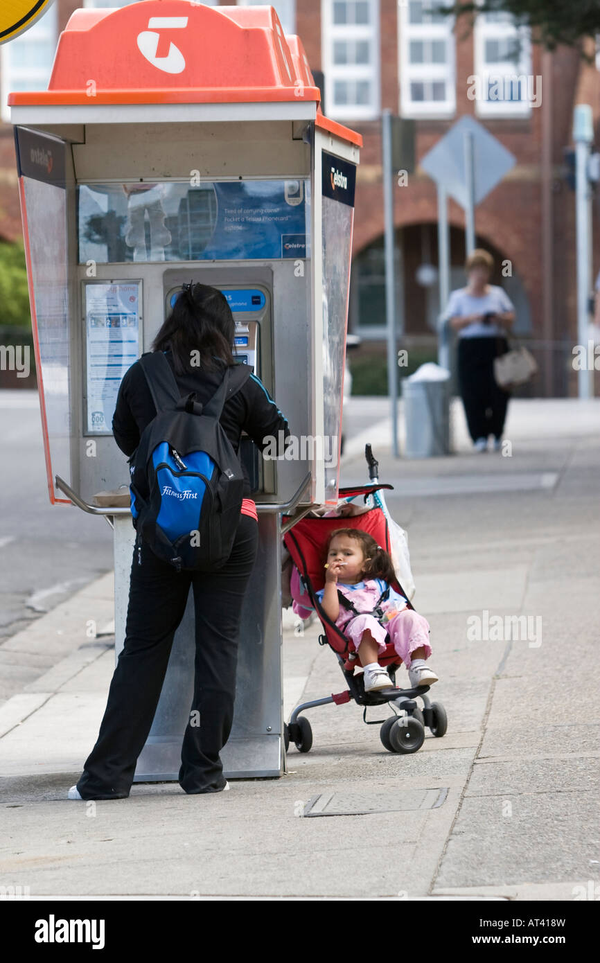 A woman uses a public telephone Stock Photo - Alamy