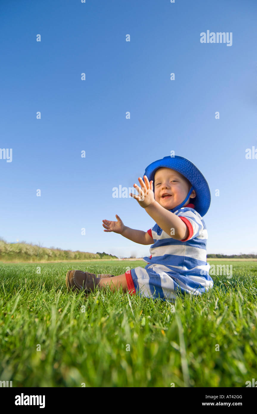 Happy toddler playing in the grass Stock Photo - Alamy