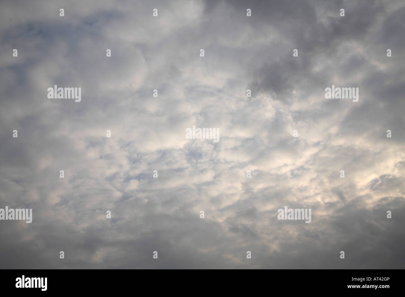 Altocumulus perlucidus. Broken mass of white clouds with a little blue ...