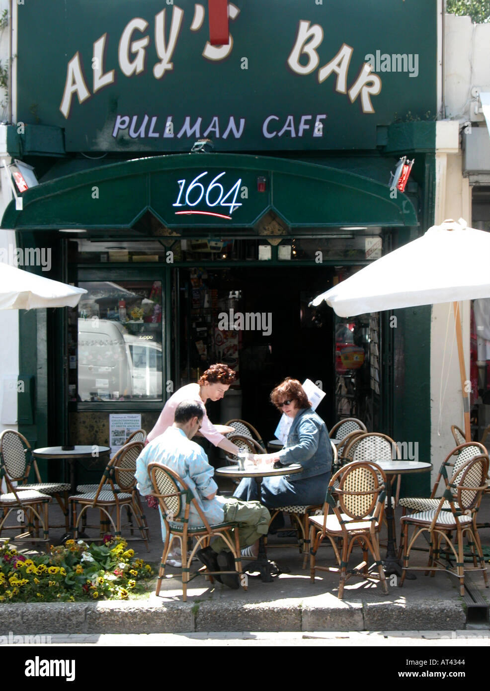 a couple being served by a waitress at Le Touquet Paris Plage in France ...