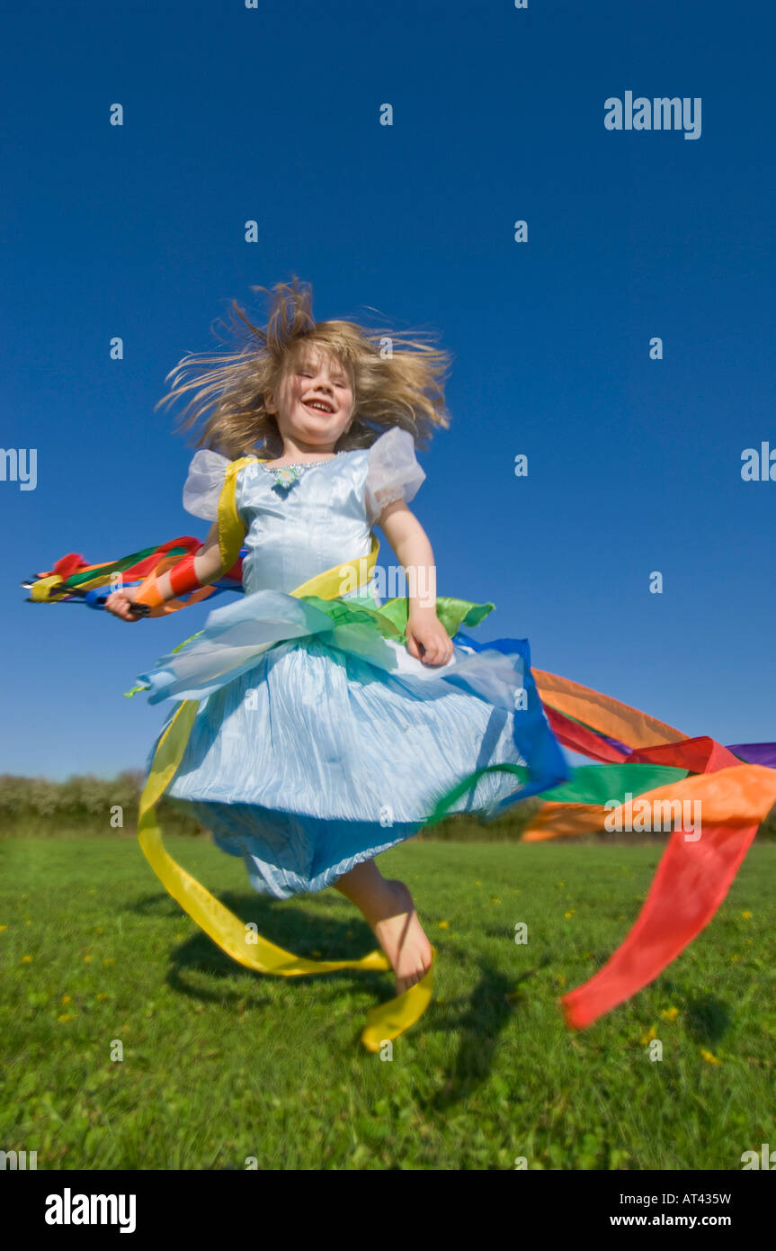 Child jumping and spinning with streamers Stock Photo - Alamy