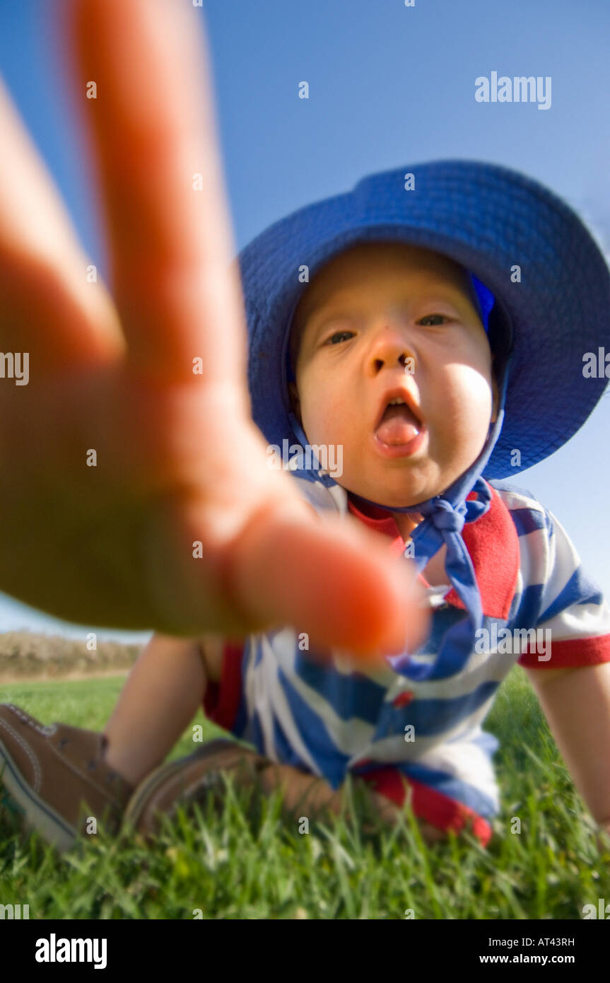 Toddler reaching for camera Stock Photo - Alamy