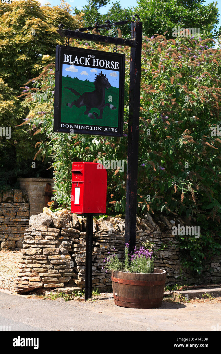 Black Horse Pub Sign and red post box Naunton Cotswolds England Stock ...