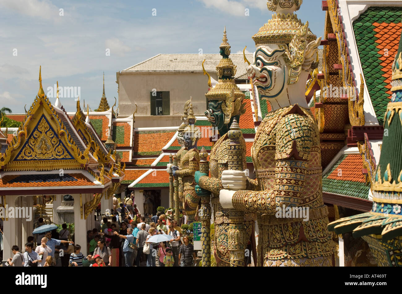 Large mythical beast statues guard people walking around on the grounds ...