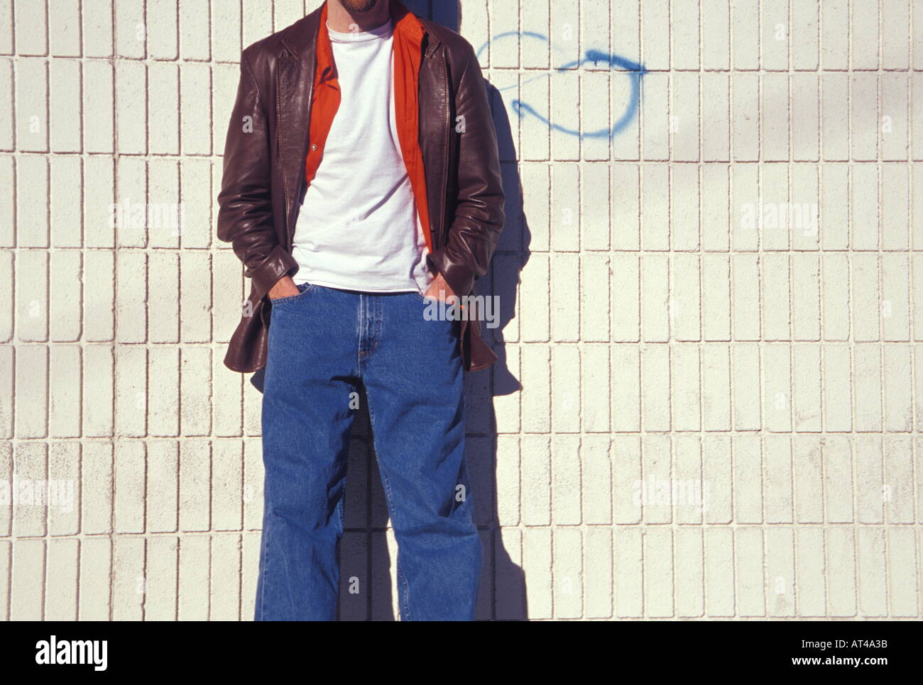 Boy Standing Against a Wall Stock Photo - Alamy
