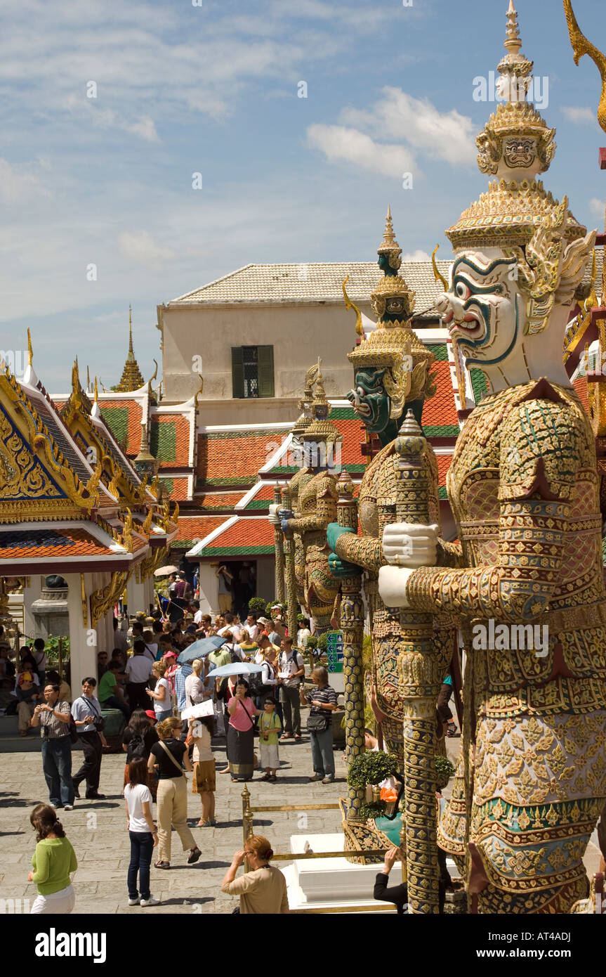 Large mythical beast statues guard people walking around on the grounds ...