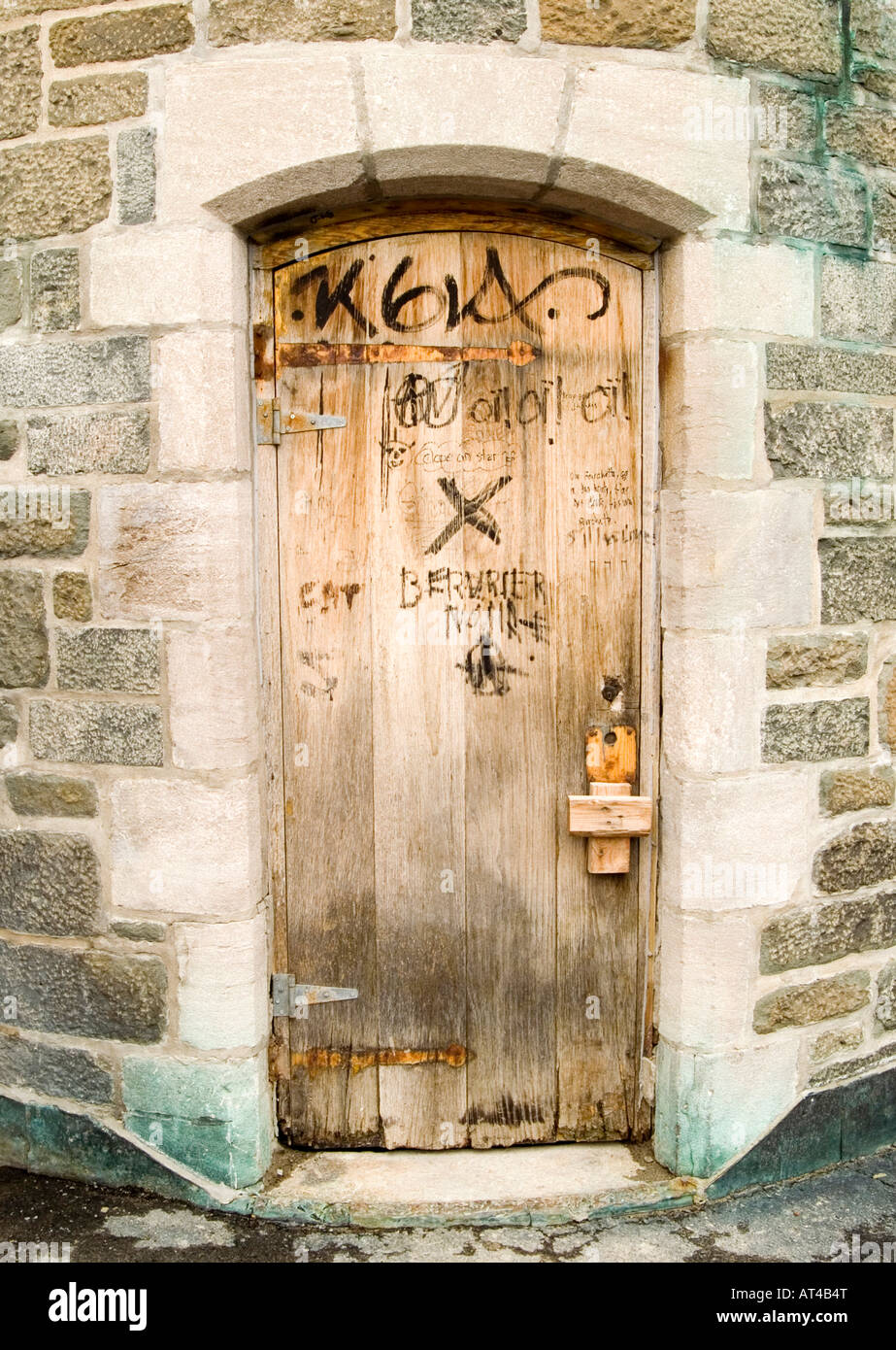 An old wooden door covered in graffiti, part of the Fortifications de ...