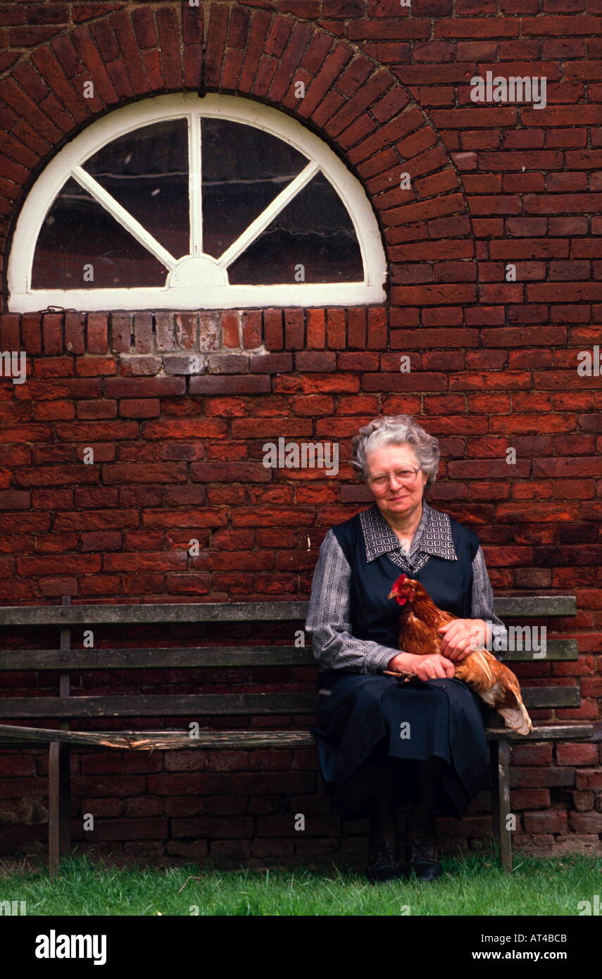 Old woman holding chicken hi-res stock photography and images - Alamy