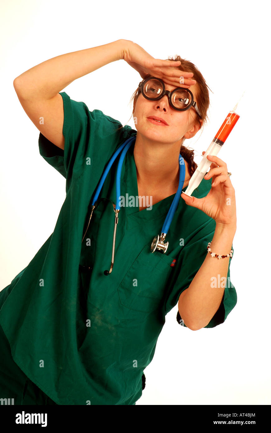 Crazy nurse with a fluid filled syringe Stock Photo - Alamy