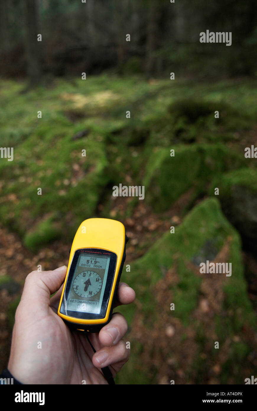 An yellow GPS receiver in a left male hand Knivsta Uppsala Lan Sweden ...
