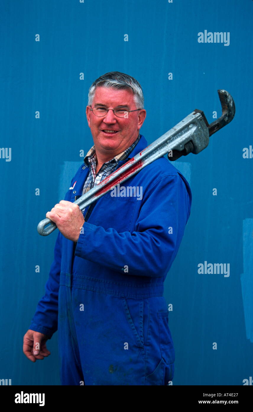 Happy Man With Huge Wrench Stock Photo - Alamy
