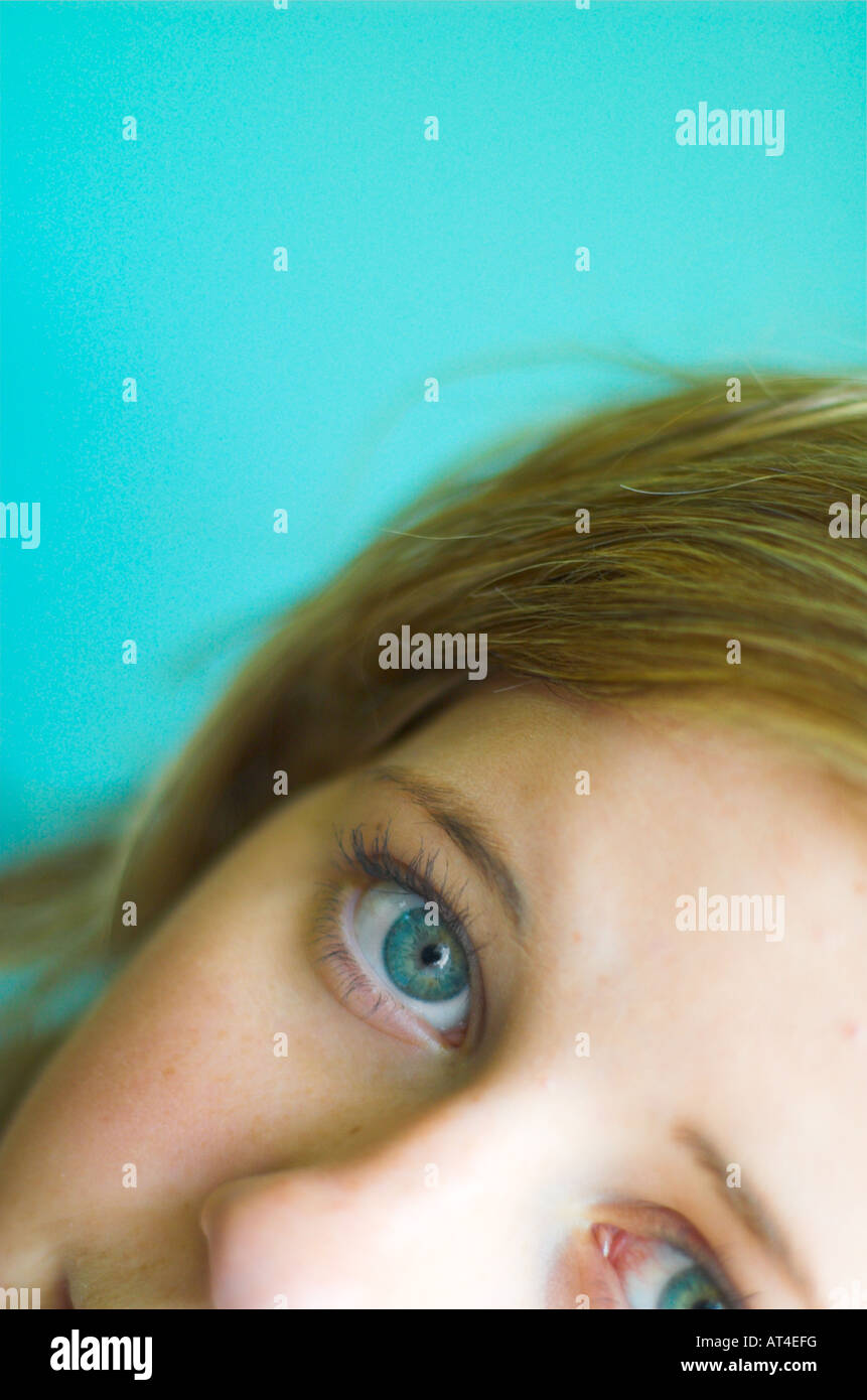 Young Woman Gazing into the Camera. Aqua Blue Background. Soft Gaze ...