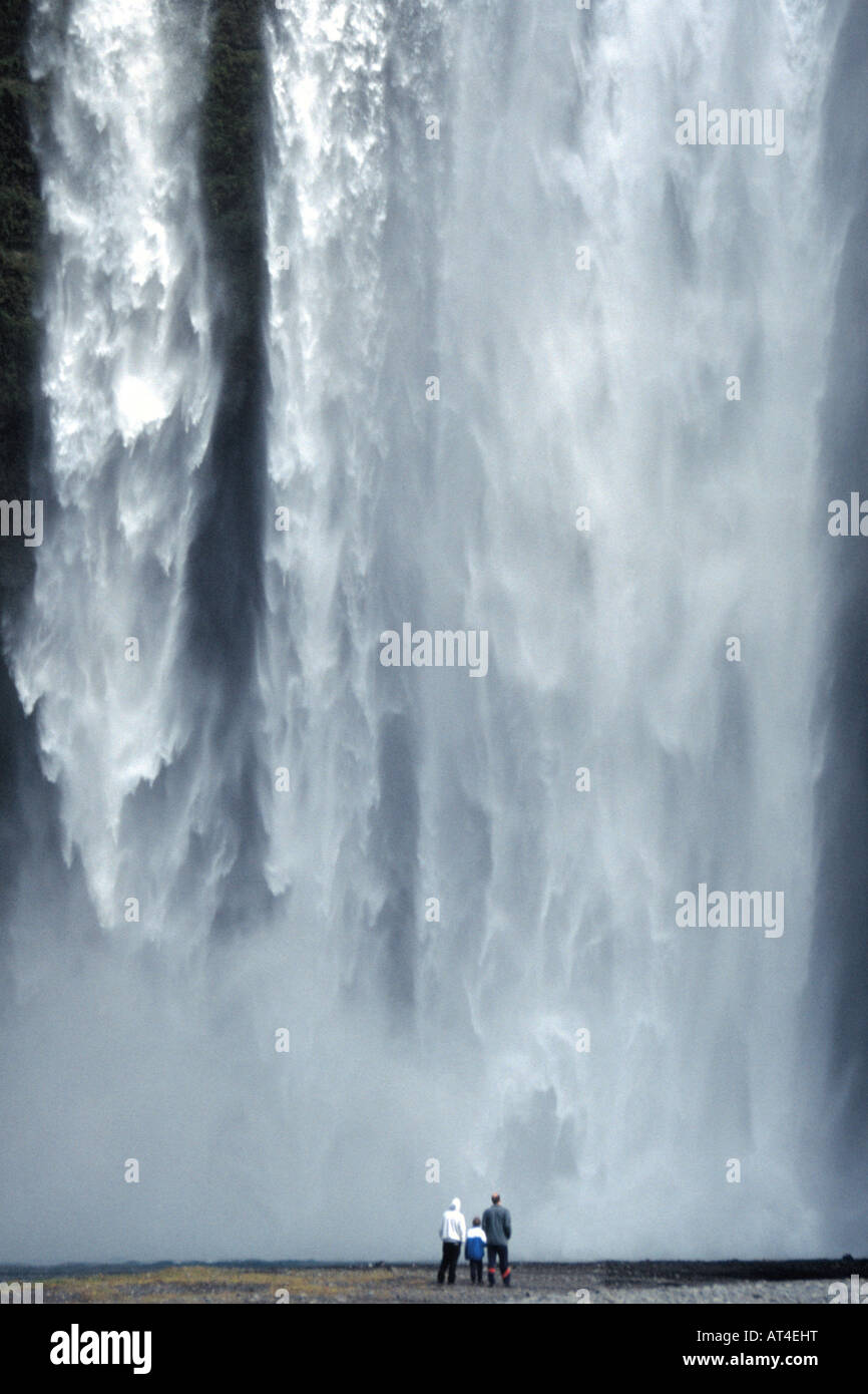 group of people in front of a waterfall Stock Photo - Alamy
