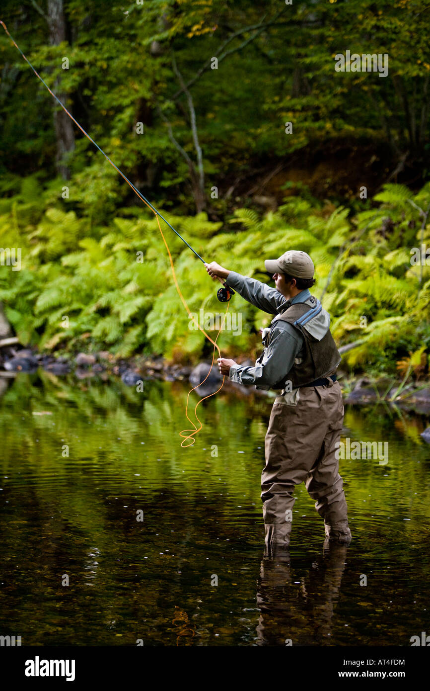 A man fly-fishing on the Isinglass River in Barrington, New Hampshire ...