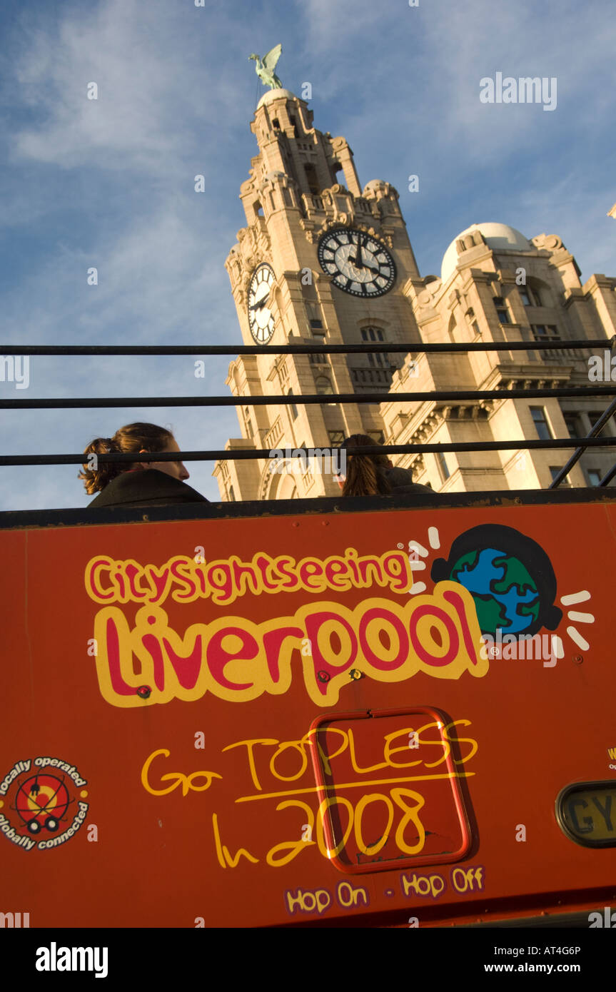 Open top tourist sightseeing red bus in front of the iconic Liver ...